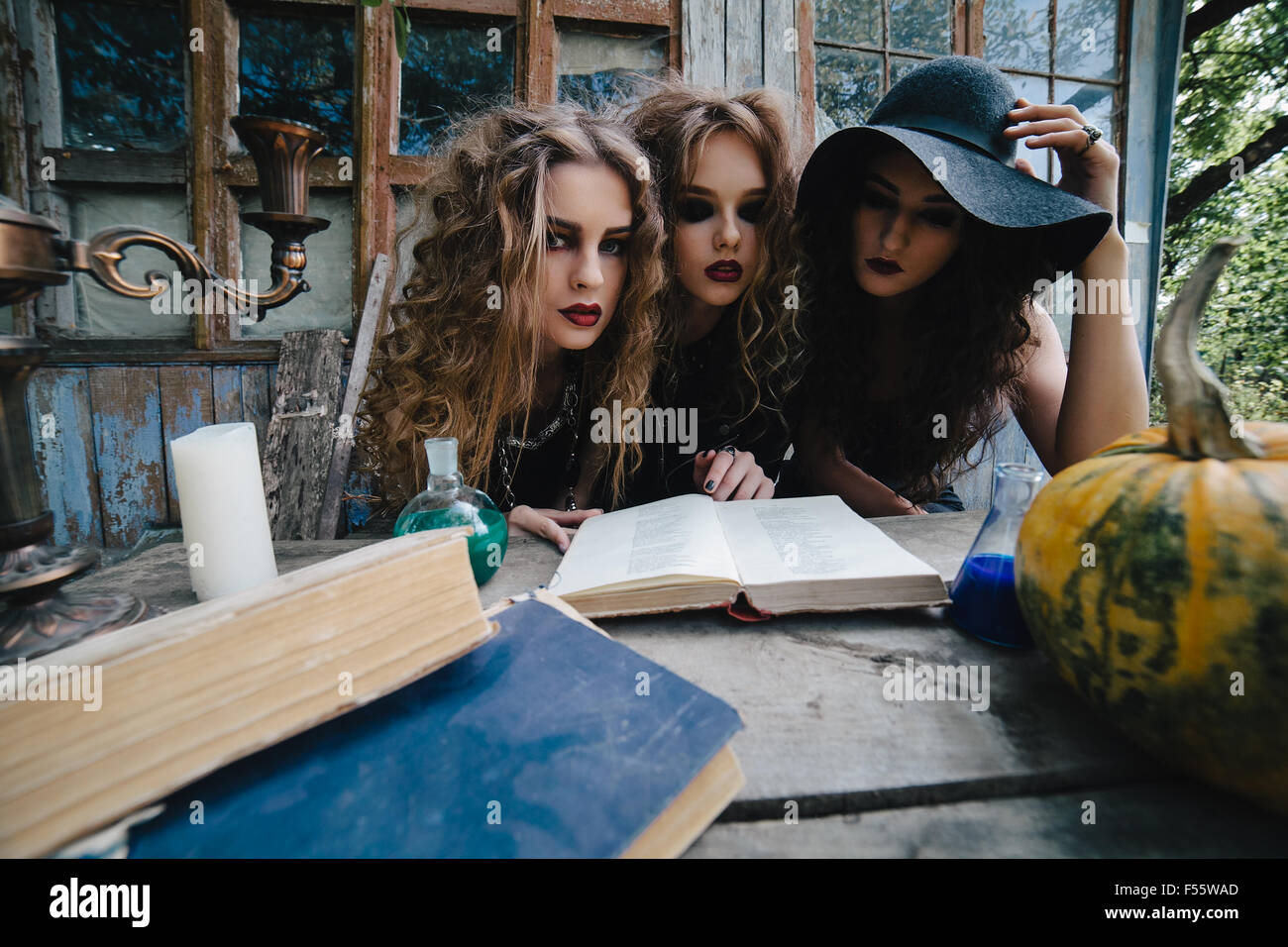 Three vintage witches perform magic ritual Stock Photo - Alamy