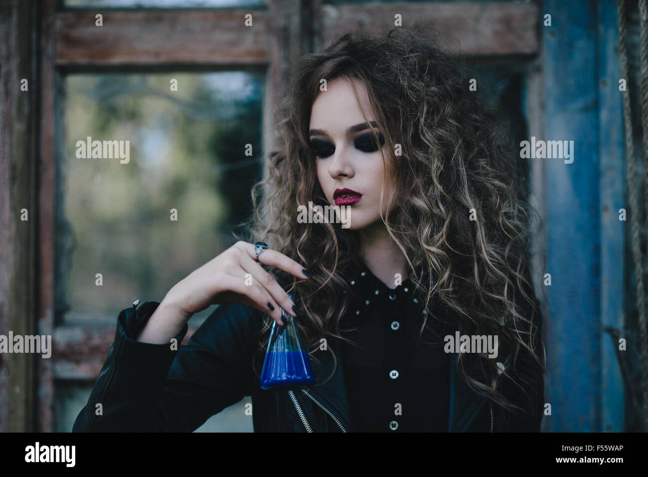 Vintage witch with elixir in hand Stock Photo - Alamy