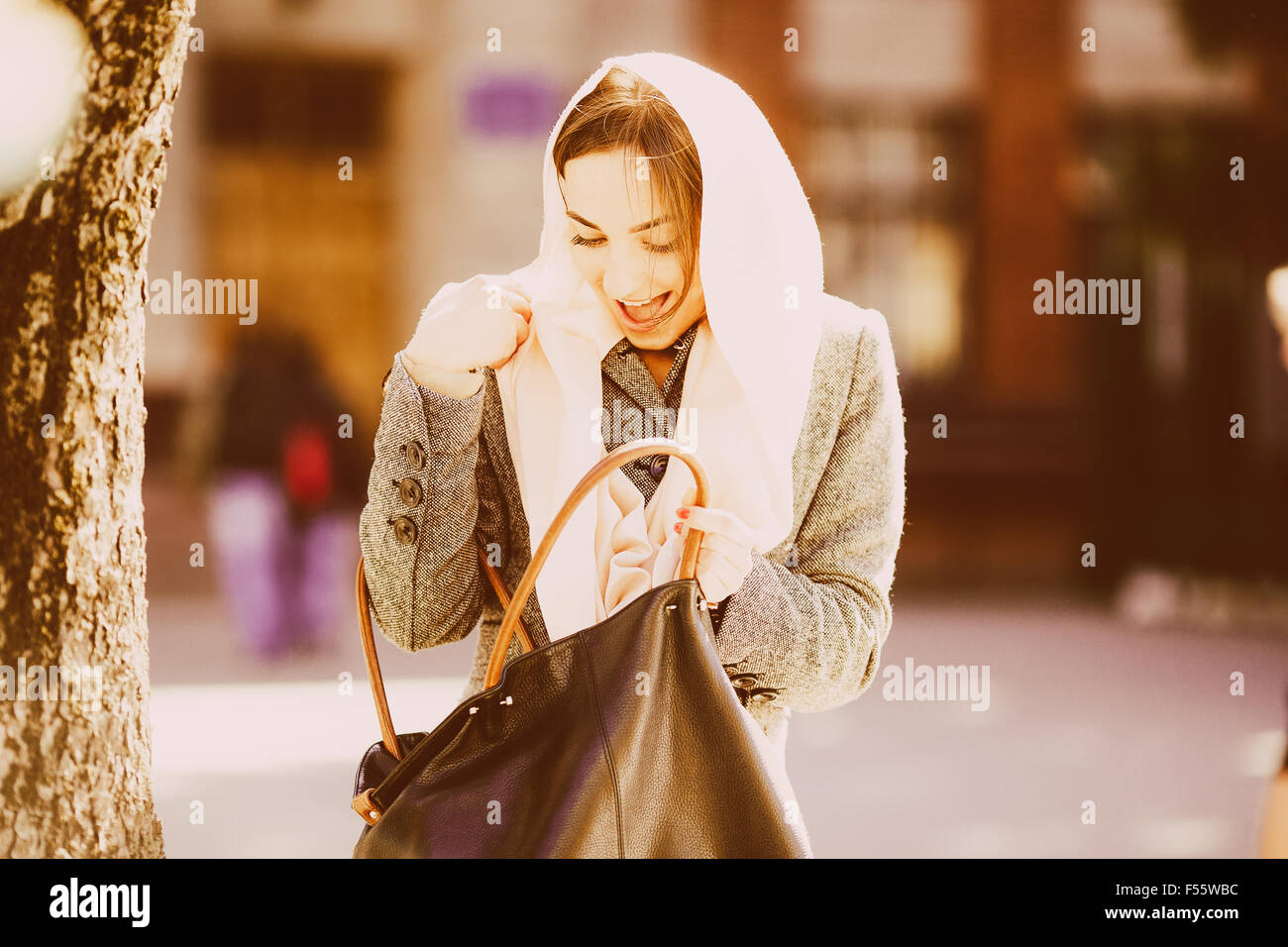 girl looking for something in a bag Stock Photo - Alamy