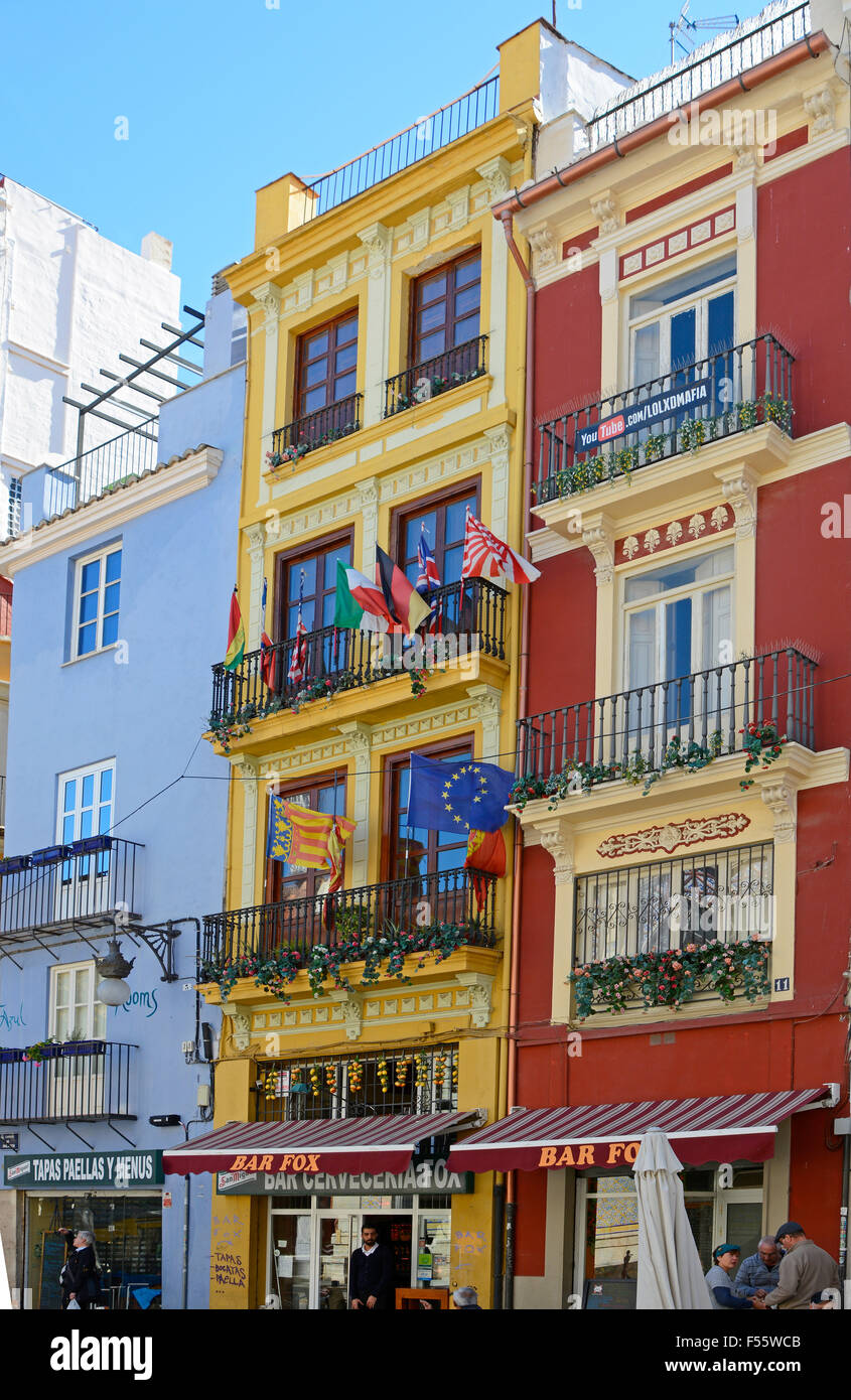 Colourful buildings with flags and flowers opposite the central market ...