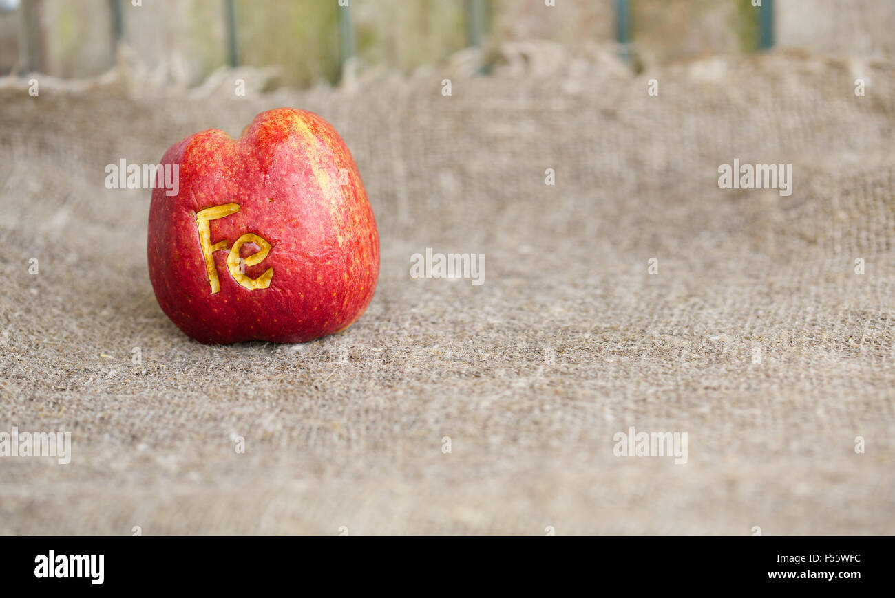 Abbreviation Fe scratched on an apple skin. Close up Stock Photo - Alamy