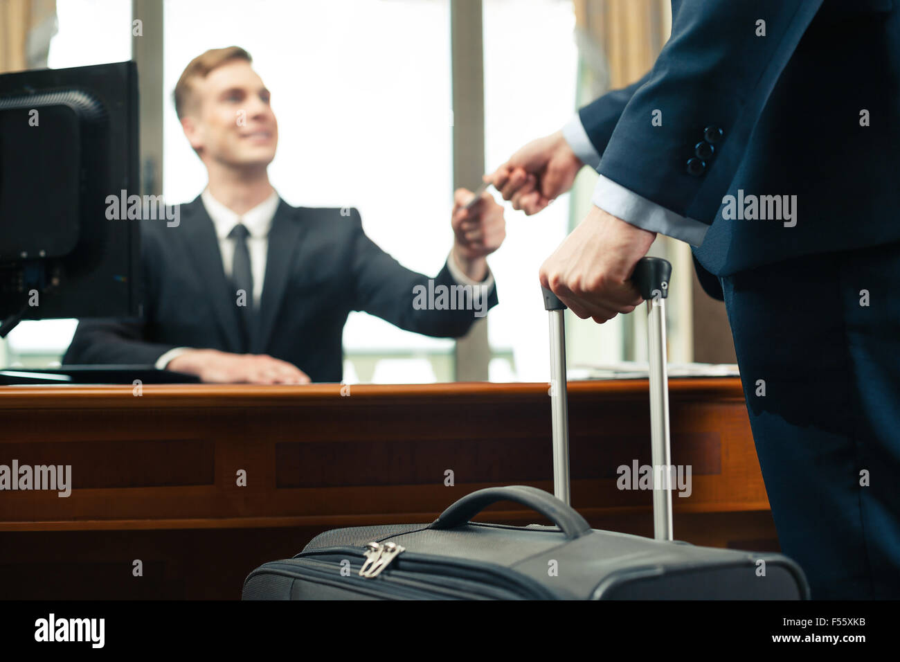 Hotel receptionist and male customer hi-res stock photography and ...