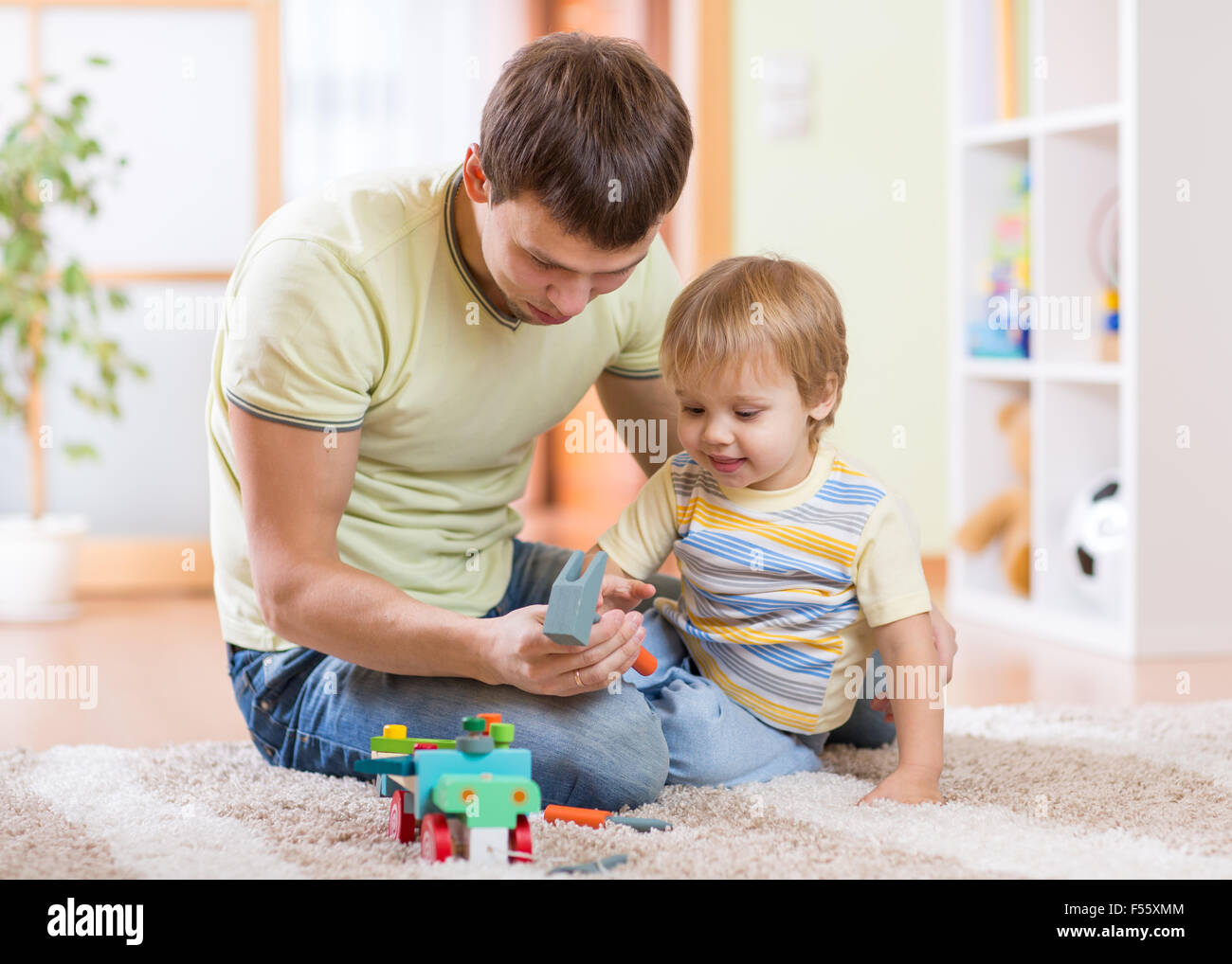Child boy and his father repair toy car at home Stock Photo - Alamy