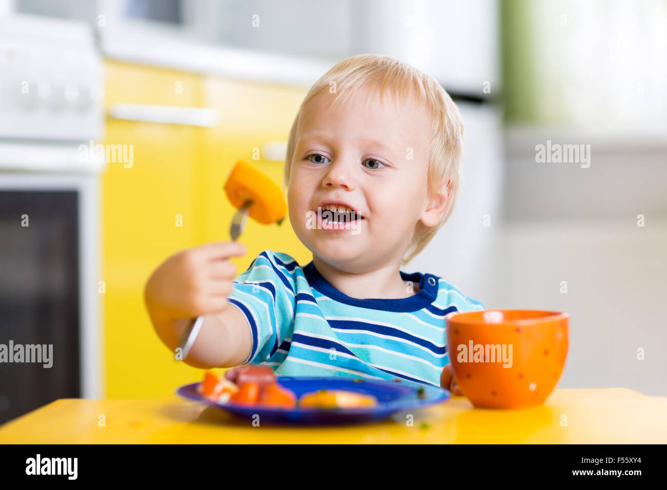 Cute child boy eats healthy food vegetables Stock Photo - Alamy