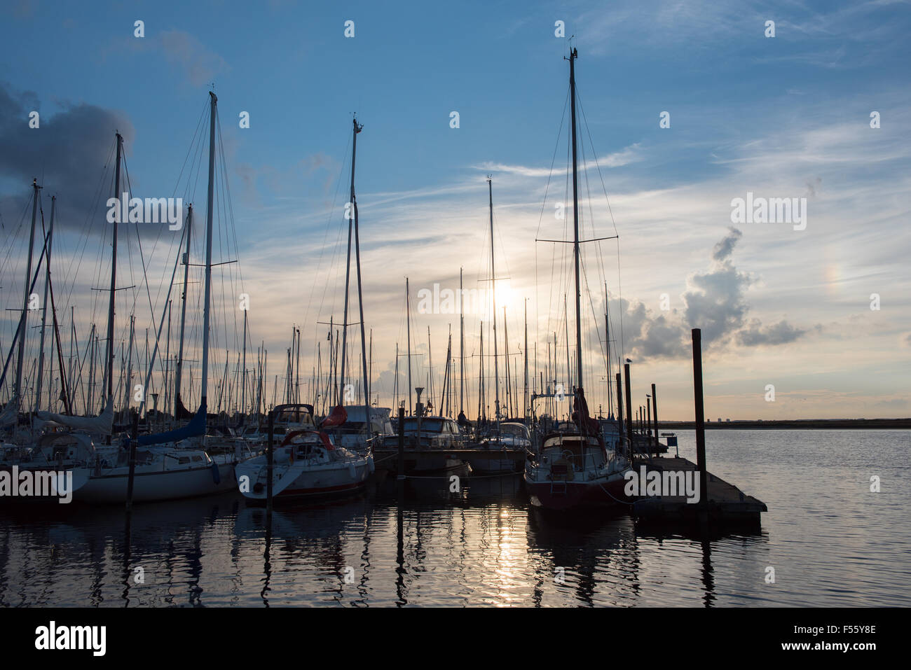 sunset over the harbor Stock Photo - Alamy