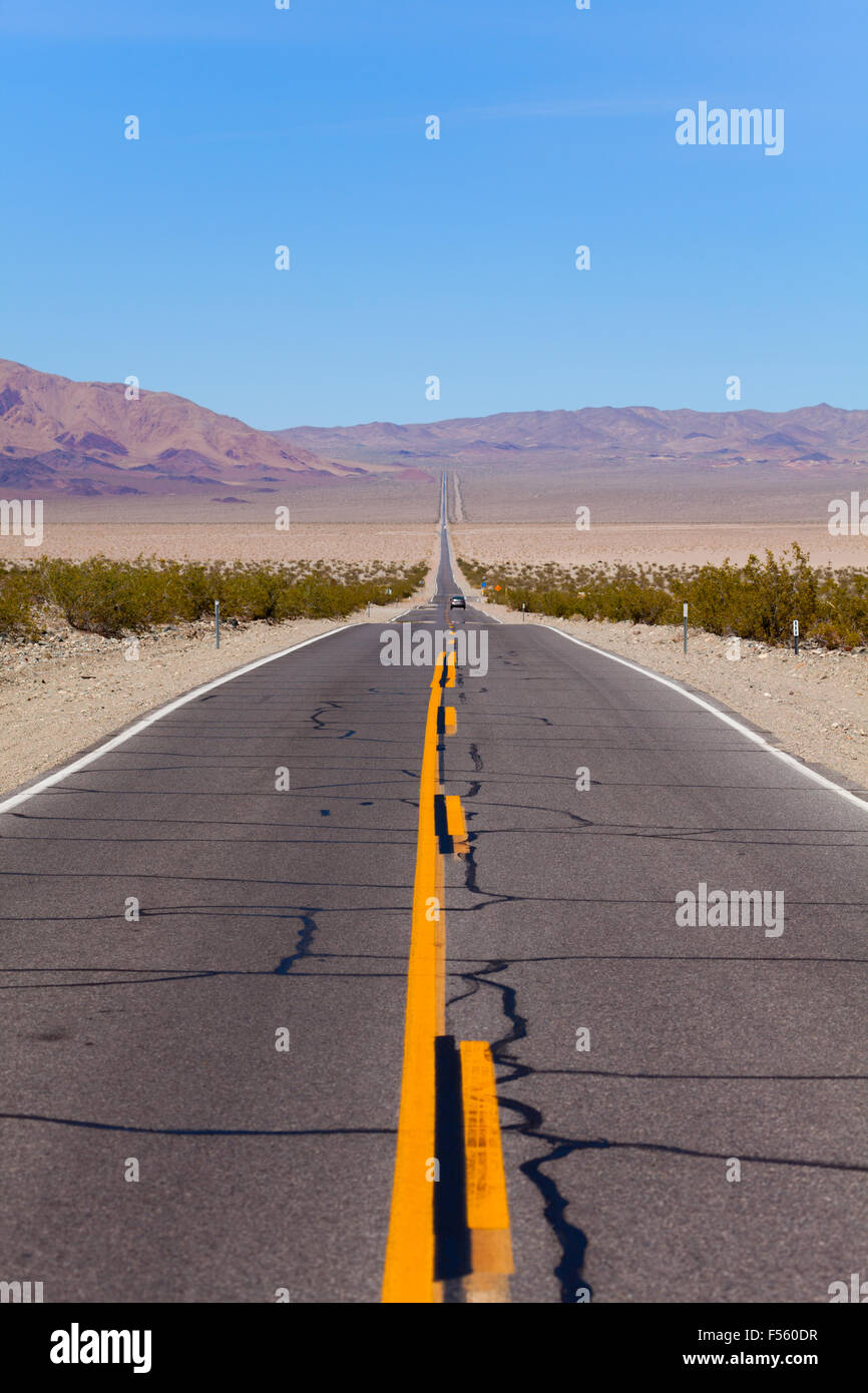Straight cracked road in desert, California, USA Stock Photo - Alamy
