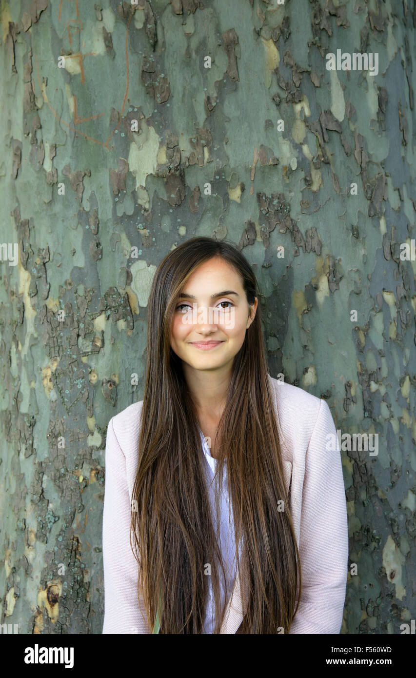 Portrait of beautiful girl on background of the tree Stock Photo - Alamy