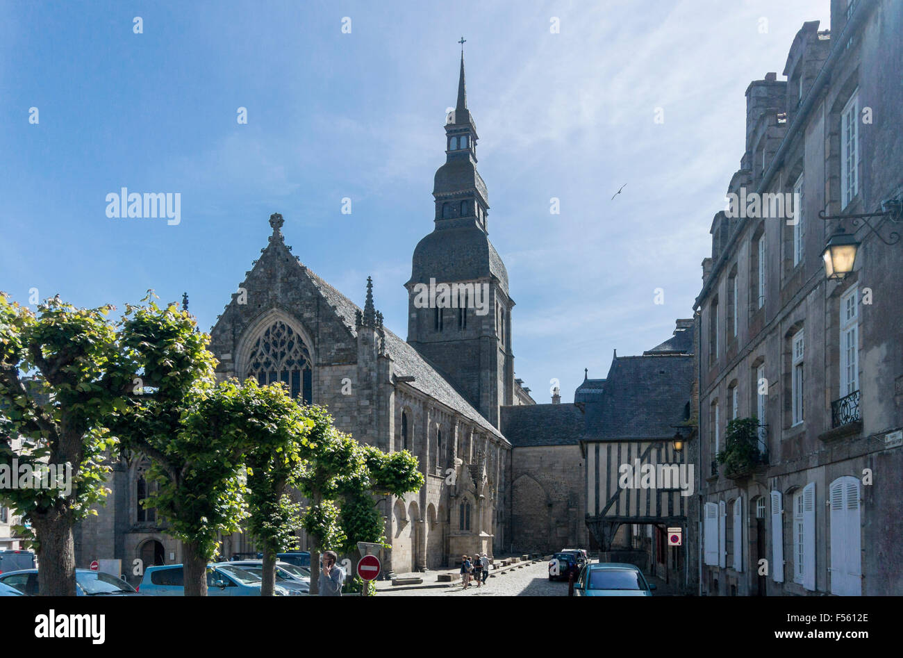 Medieval cobbled street and the Basilique Saint-Sauveur, church in the ...