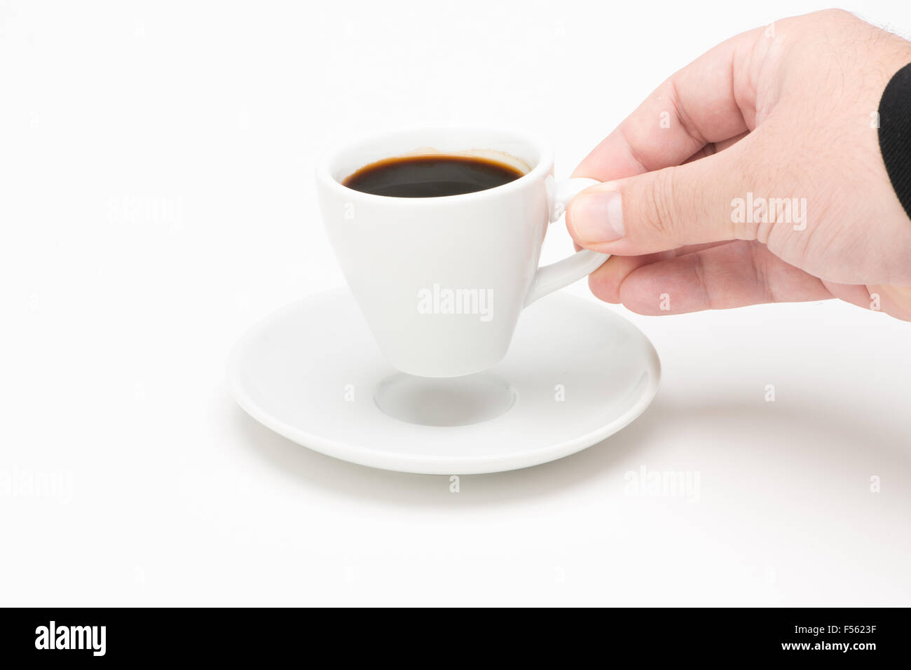 Cup of coffee with hand on white background Stock Photo - Alamy