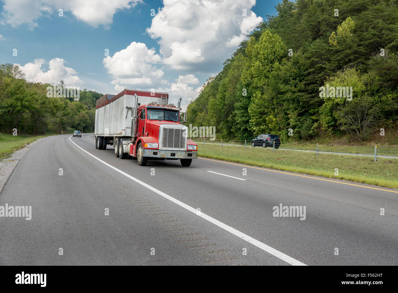 Red Semi Tractor-Trailer Driving Down a Highway With Lots of Copy Space ...