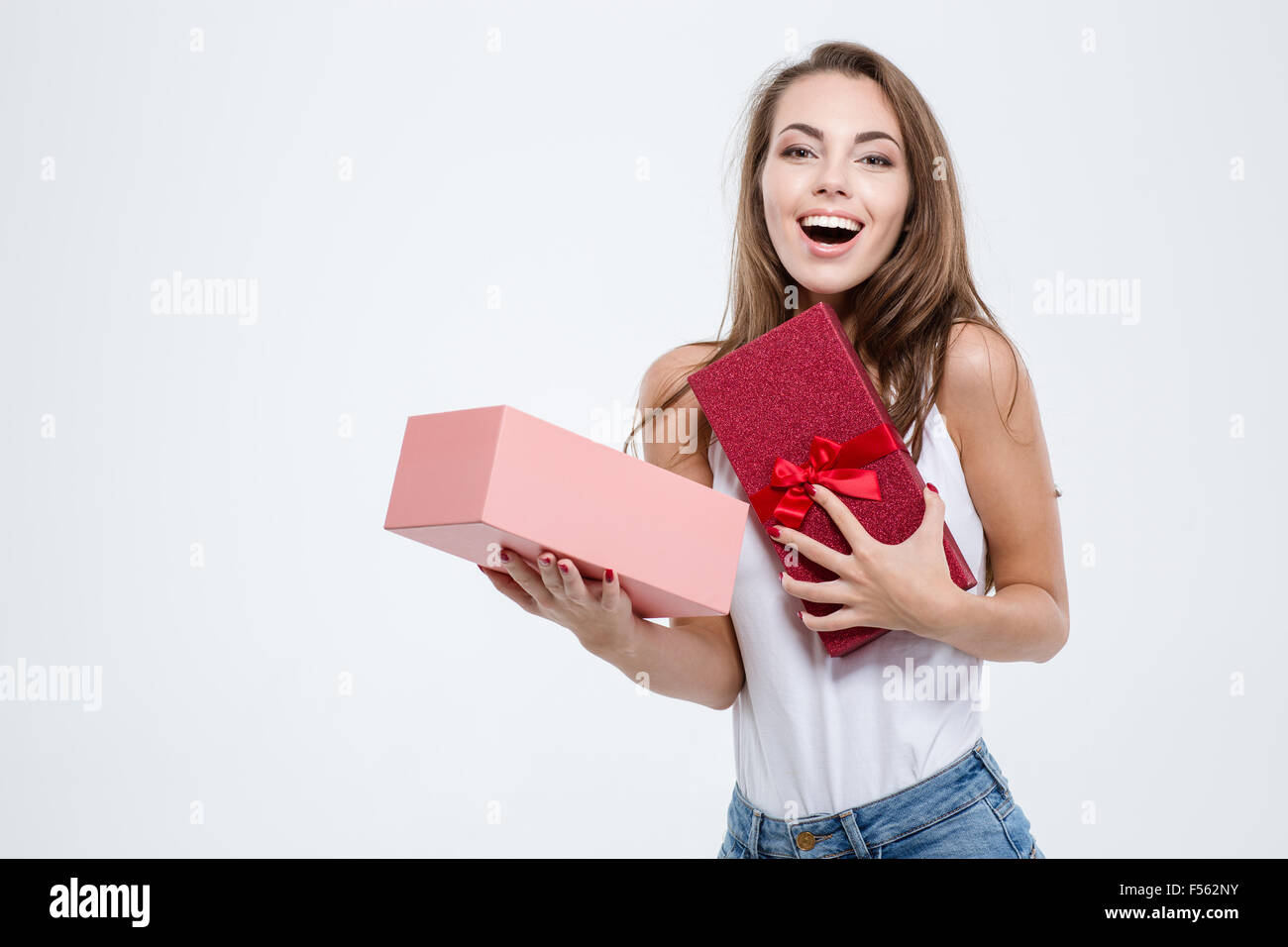 Portrait of a cheerful woman opening gift box isolated on a white ...