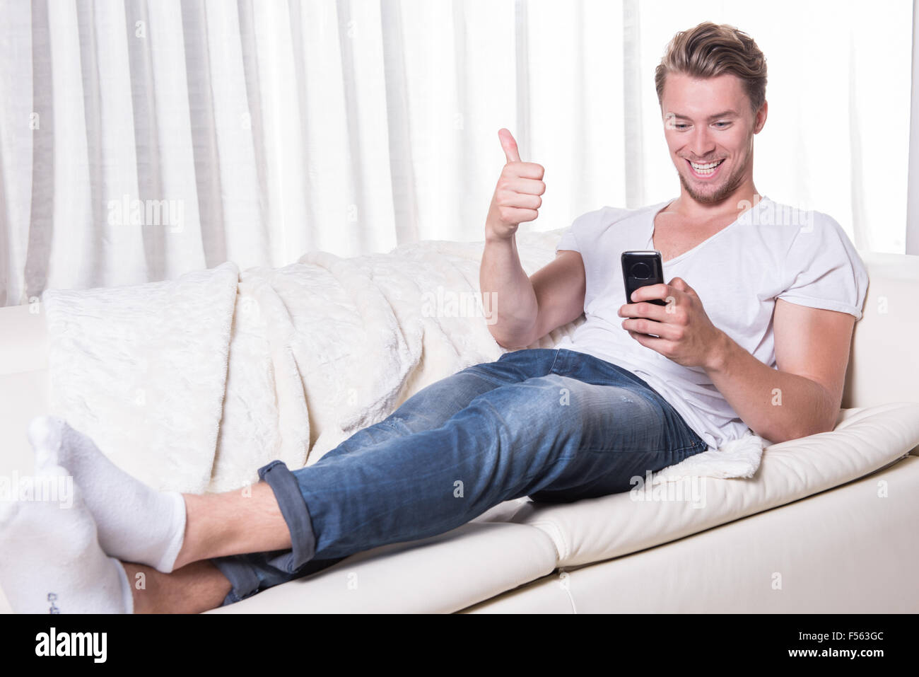 young man likes message on smartphone Stock Photo - Alamy
