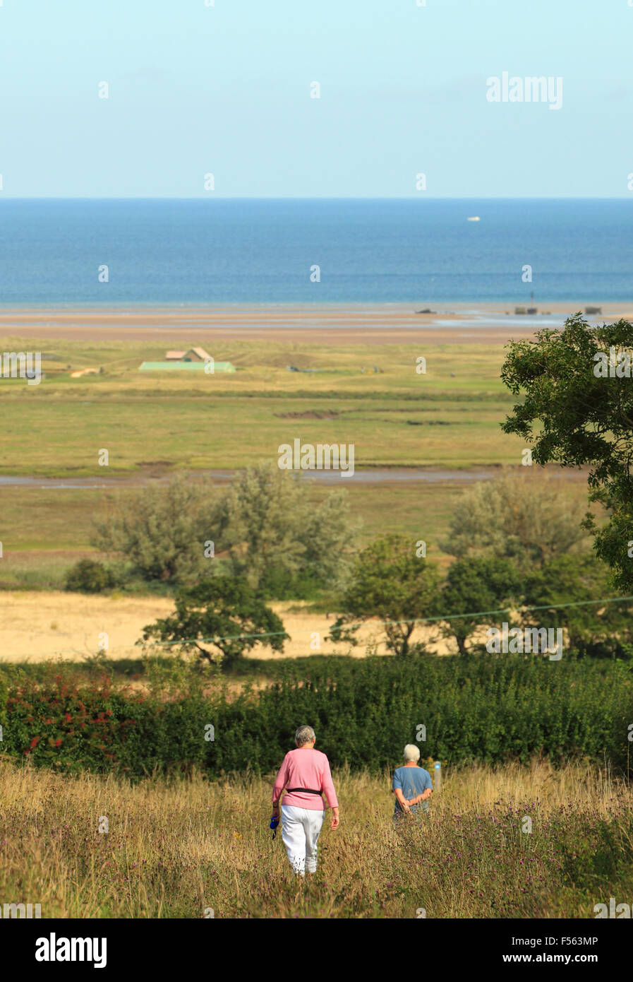 Two women walking on Barrow Common above the village of Brancaster ...