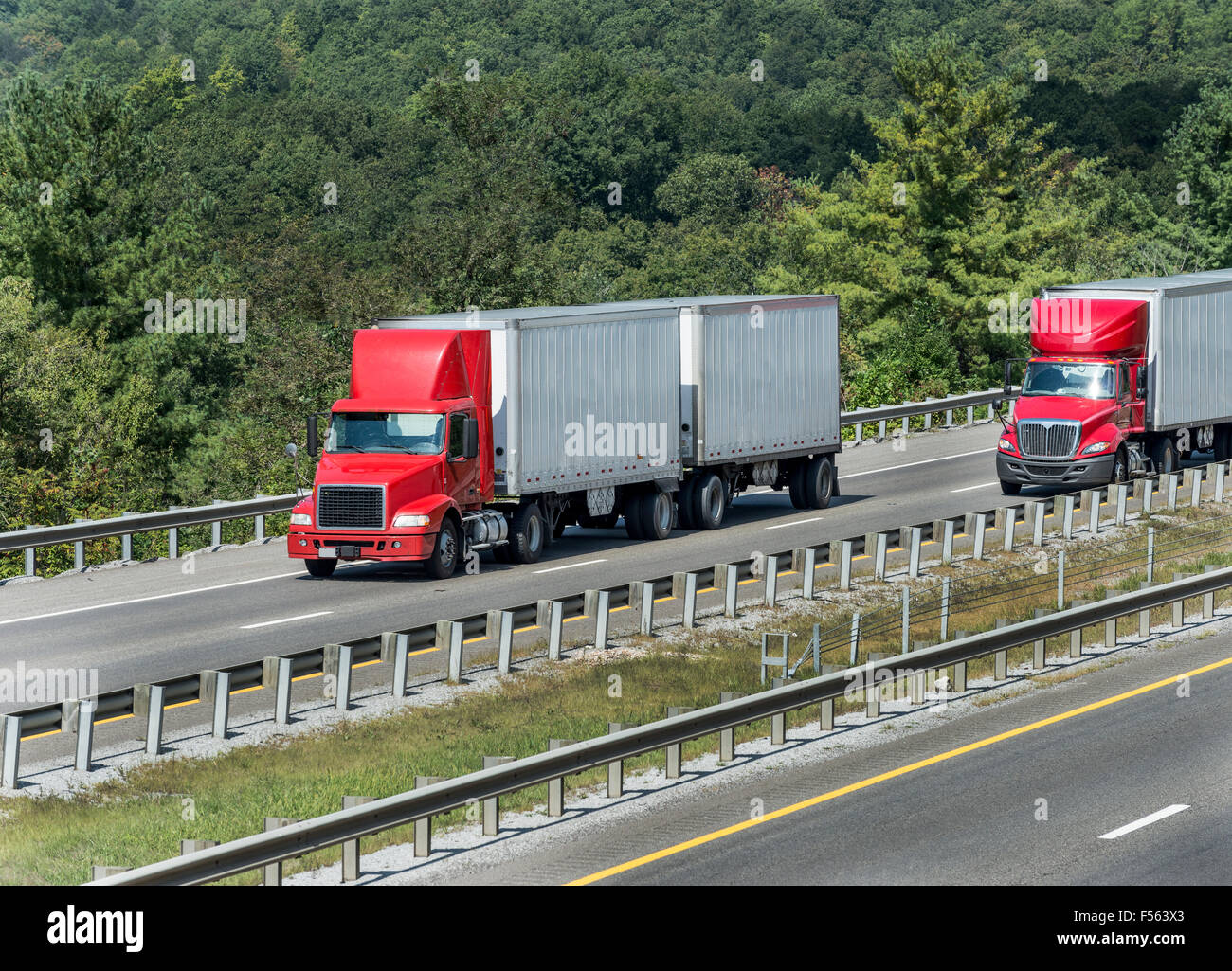 Two Red Semi Trucks On The Interstate Stock Photo - Alamy