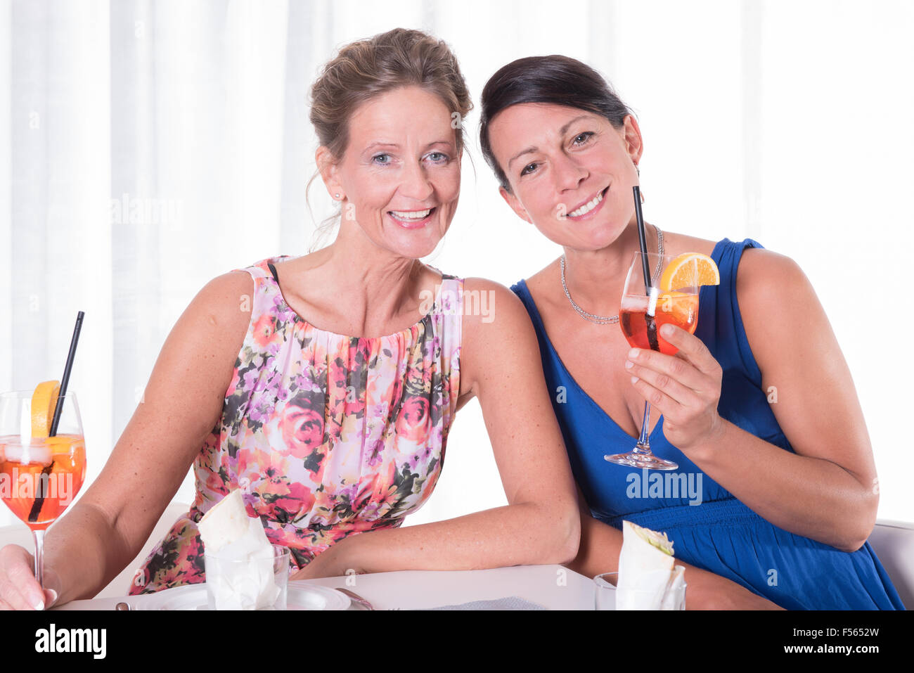 two attractive women having a drink together Stock Photo - Alamy