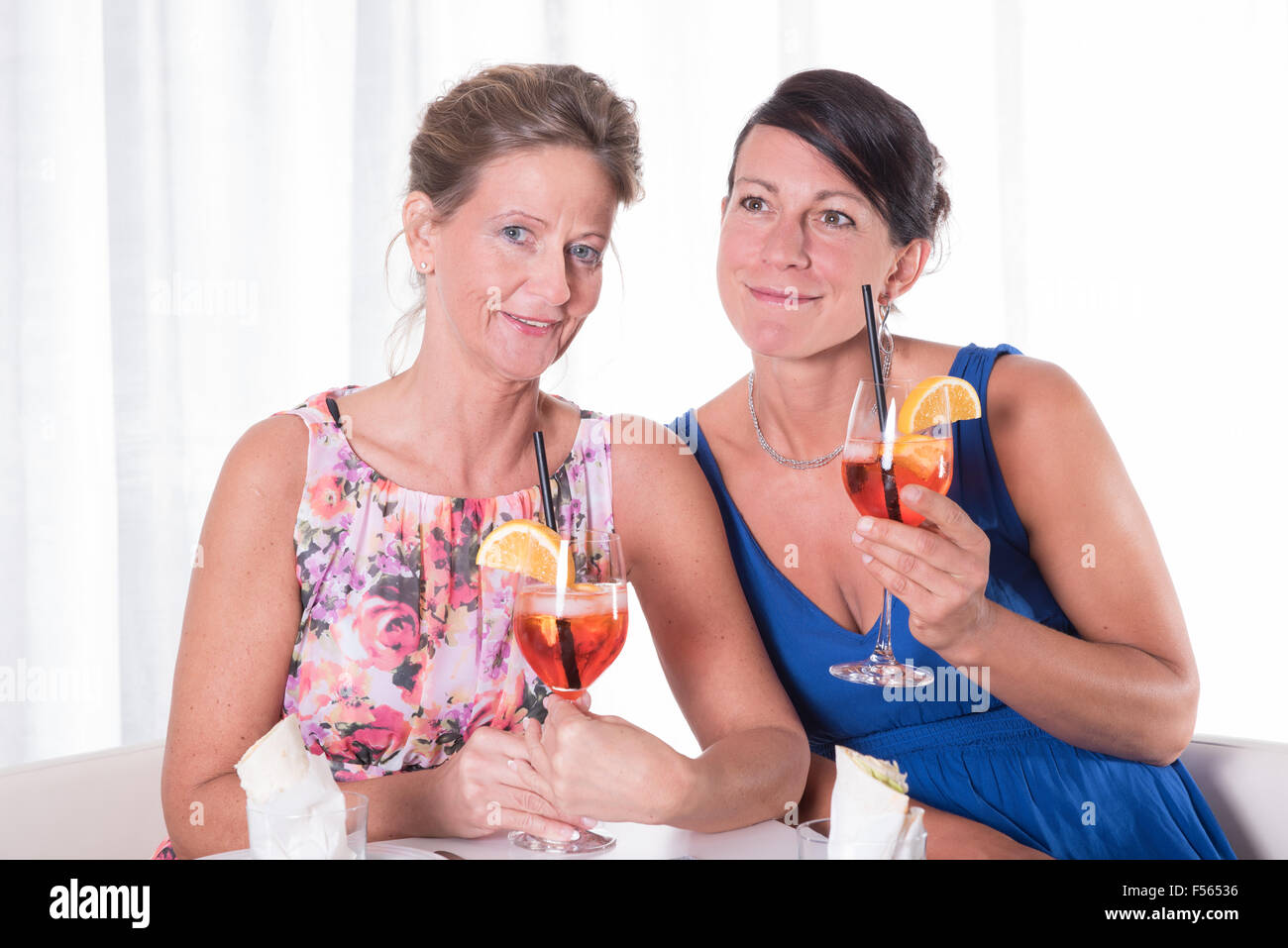 two attractive women having a drink together Stock Photo - Alamy