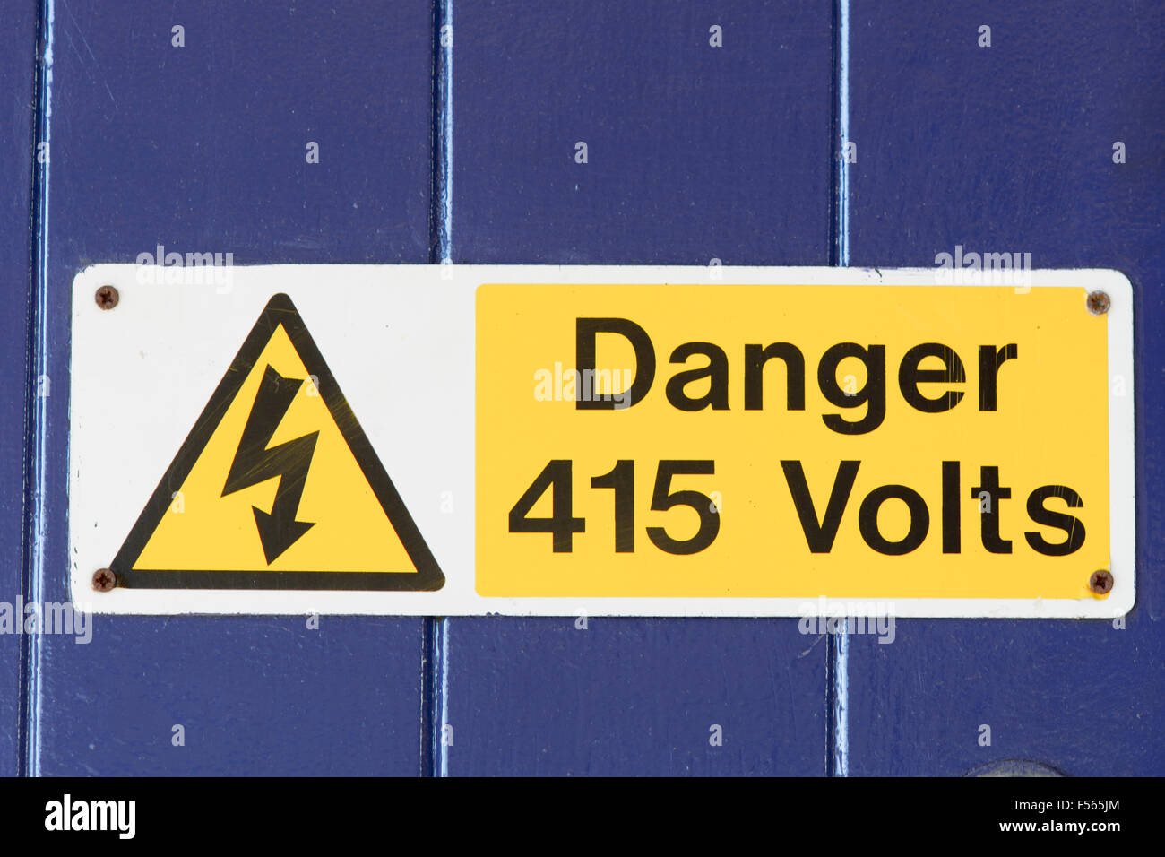 Danger 415 volts sign with symbol on wooden door Stock Photo - Alamy