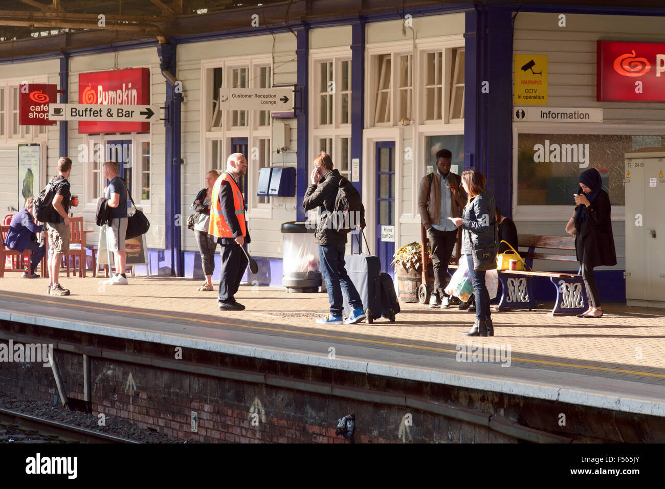 Passengers waiting for train to arrive at Newton Abbot Railway Station ...