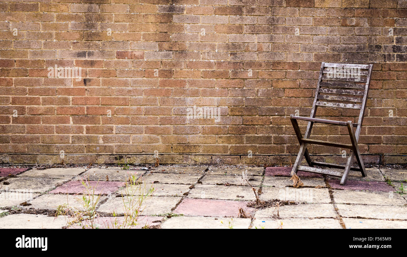 A Weathered Garden Chair on an Overgrown Patio Stock Photo - Alamy