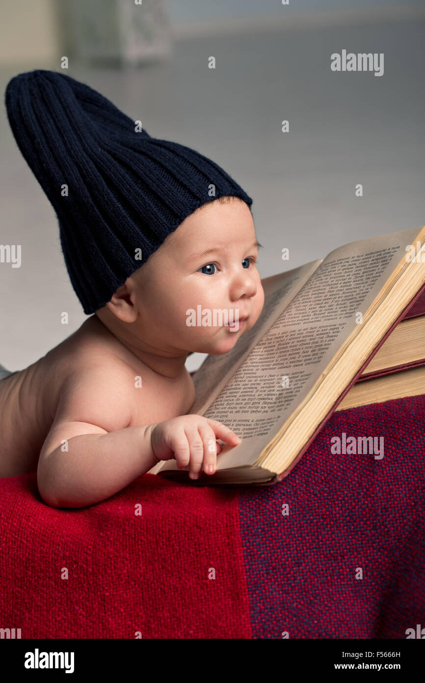 newborn baby lying on pile of books Stock Photo - Alamy