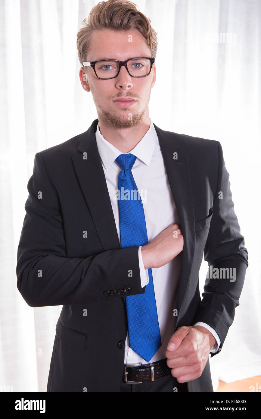 young business man taking something out of his pocket Stock Photo - Alamy