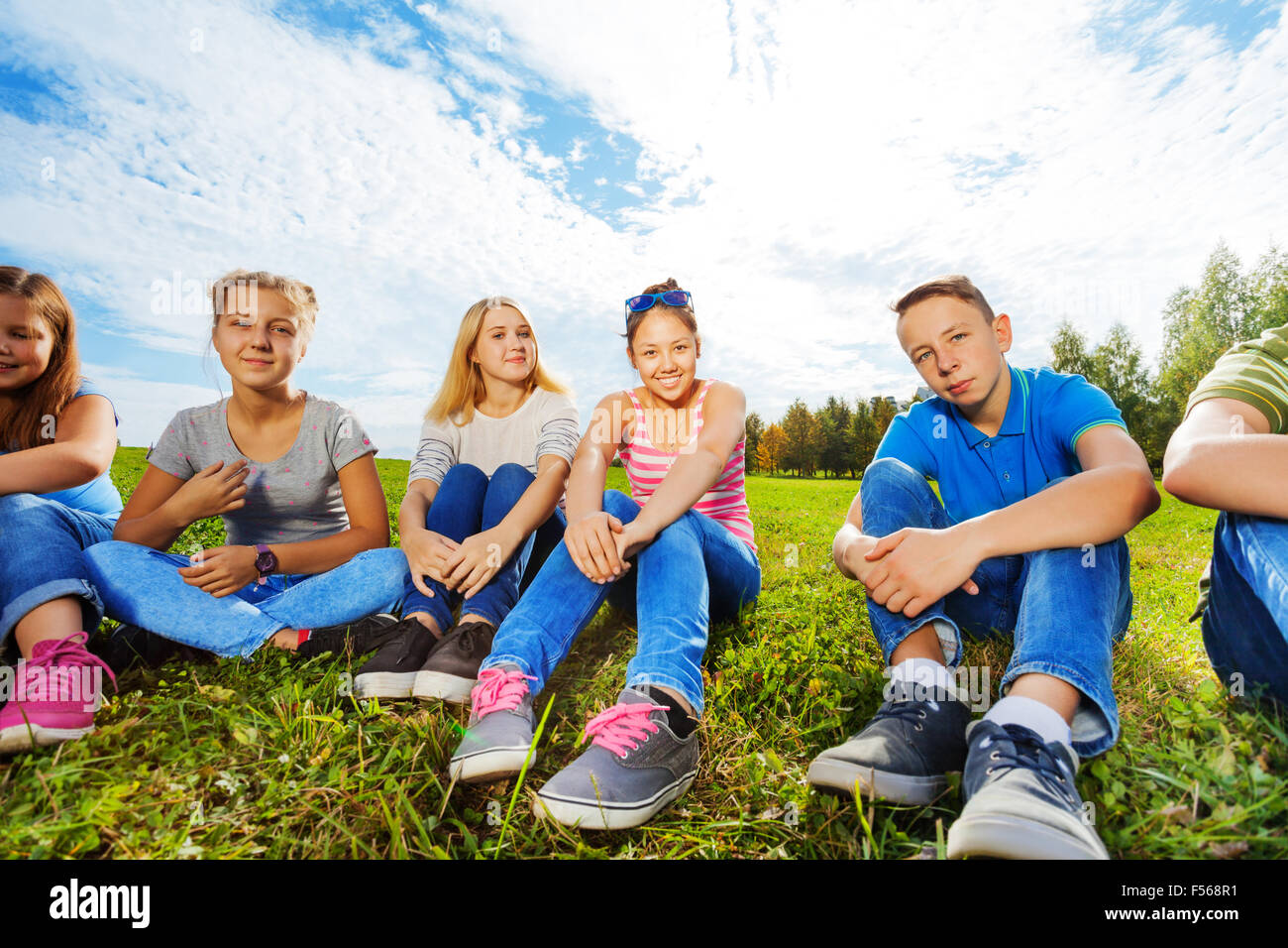Smiling international friends sitting together Stock Photo - Alamy