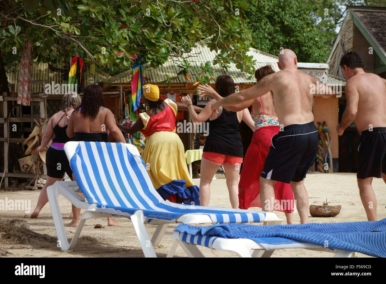Jamaican woman in traditional dress gives dance classes to tourists ...