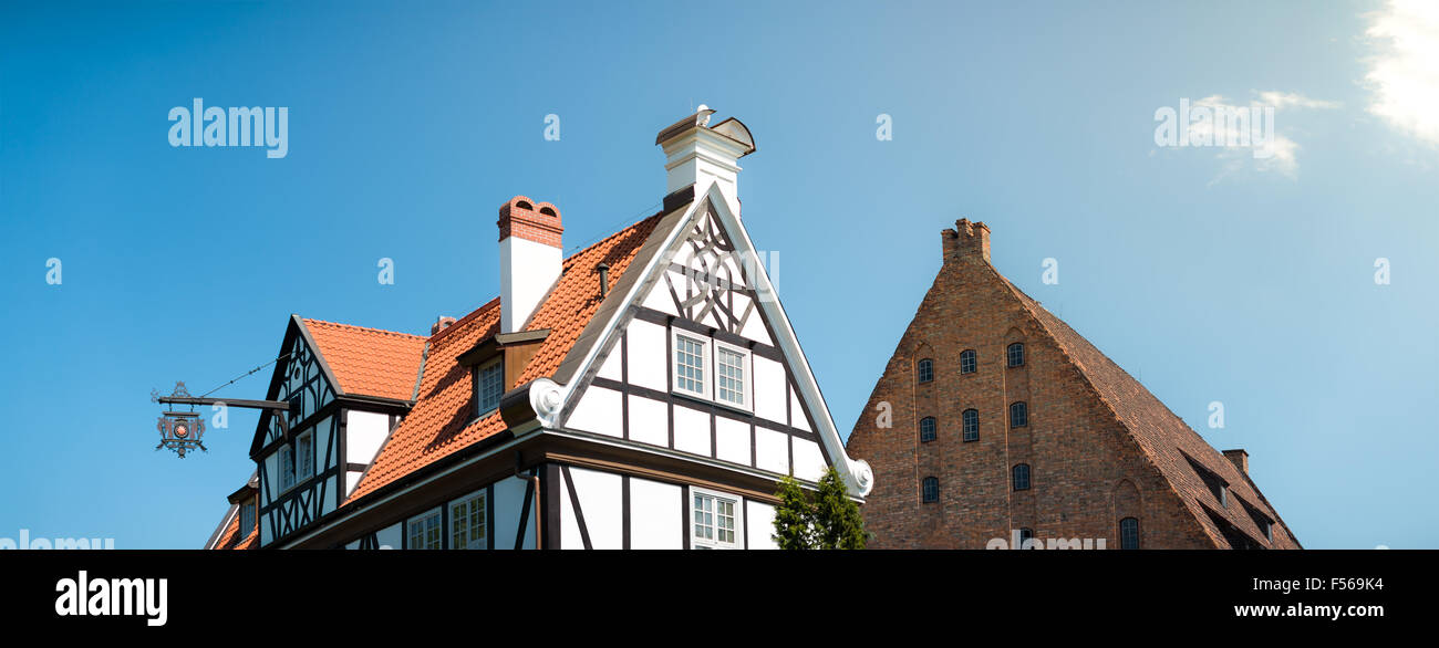 Old half-timbered house and medieval grand mill in street of Gdansk ...