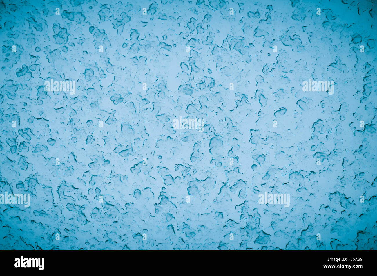 Snowed window blue abstract, texture of rain and snow, melting drops ...