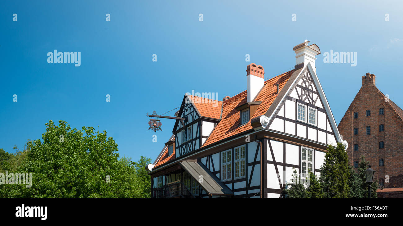 Old half-timbered house and medieval grand mill in street of Gdansk ...
