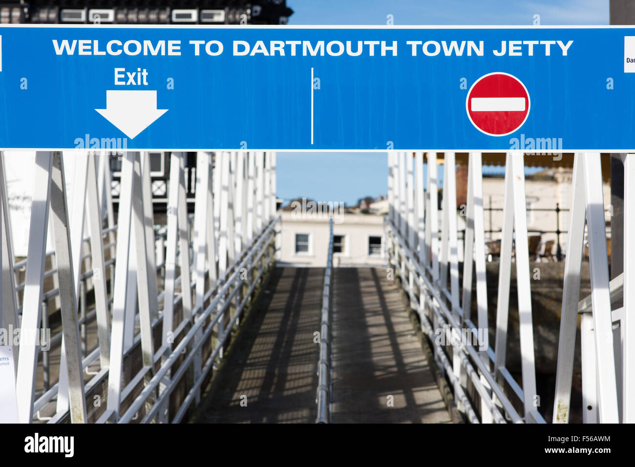 Exit and entry signs above the empty jetty leading off the River Dart ...