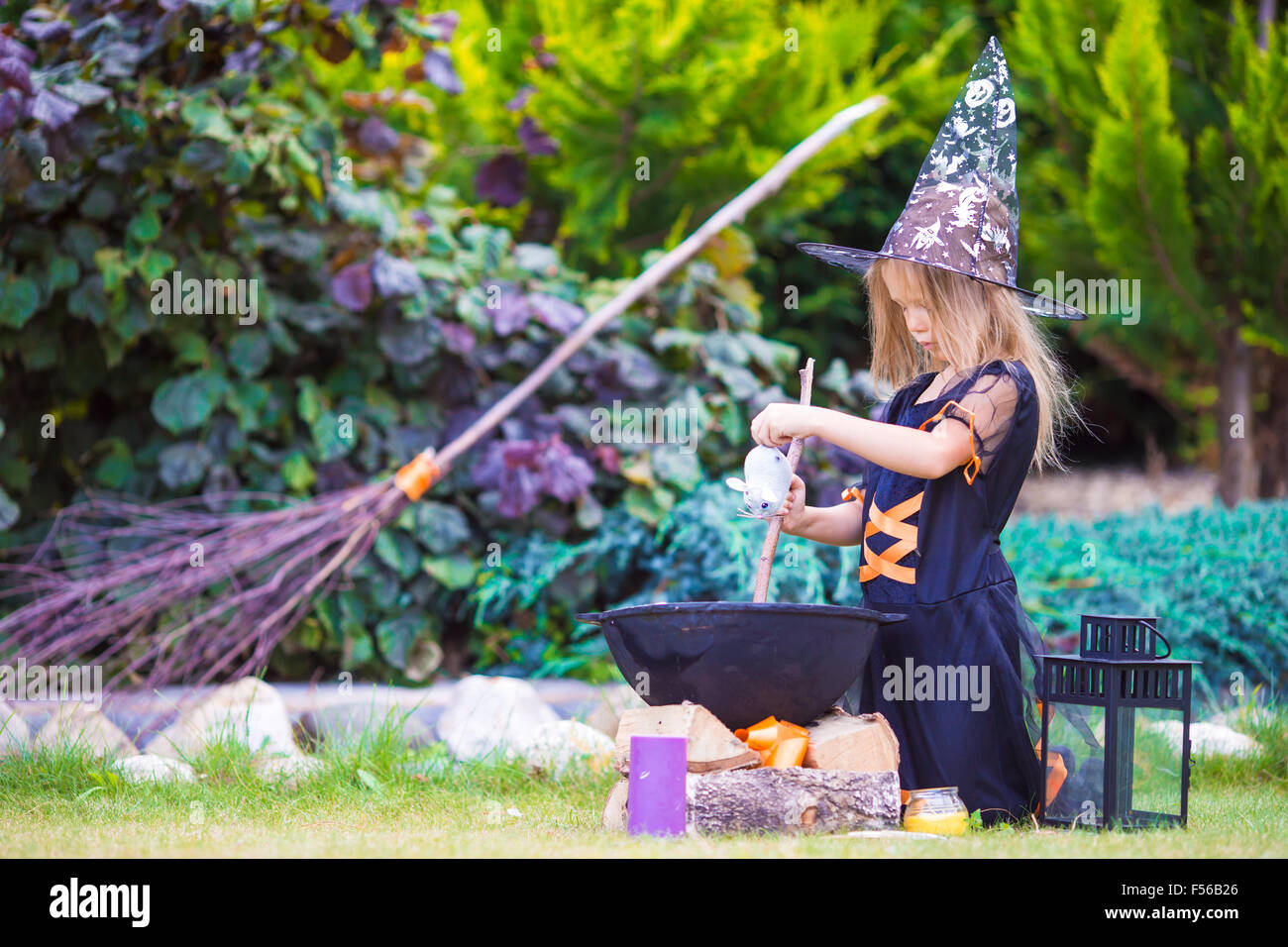 Adorable amasing little girl wearing witch costume on Halloween. Trick ...
