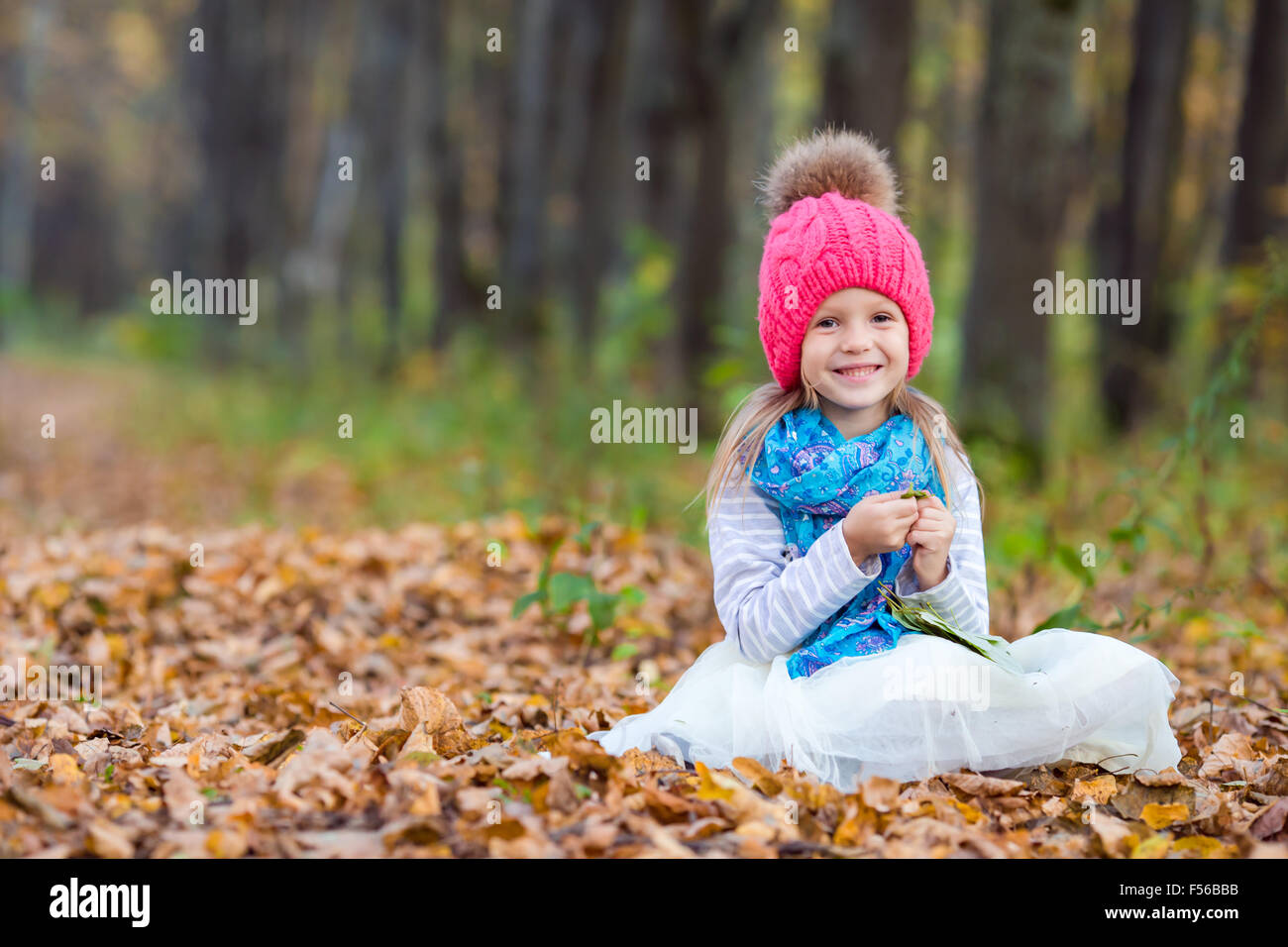 Adorable little girl outdoors at beautiful autumn day Stock Photo - Alamy