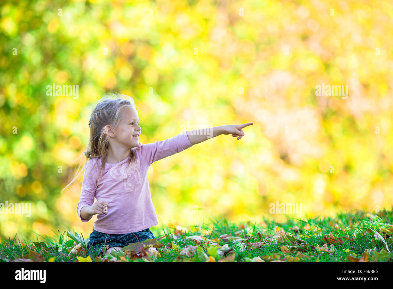 Adorable little girl outdoors at beautiful autumn day Stock Photo - Alamy