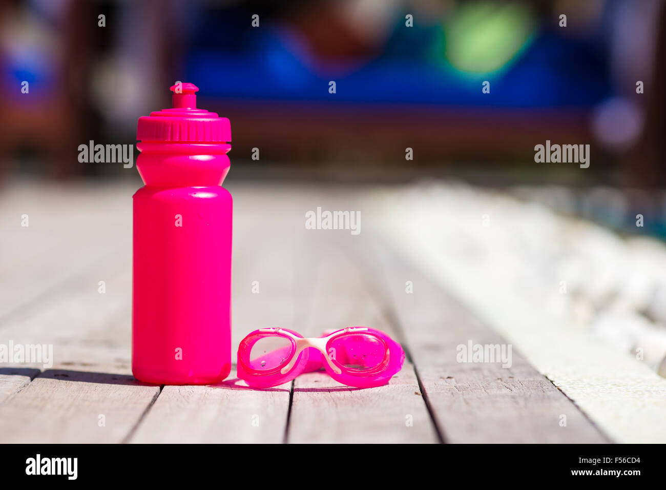 Pink sporty water bottle near swimming pool Stock Photo - Alamy