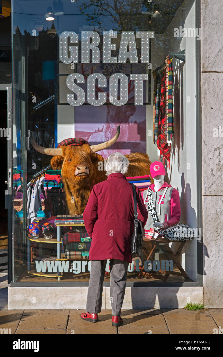An elderly woman looks iinto the window of the Great Scot Store on ...