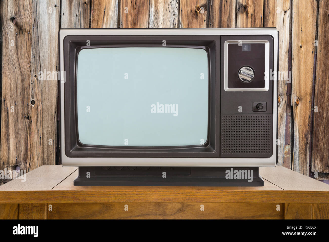 Old television and table with rustic wood wall Stock Photo - Alamy