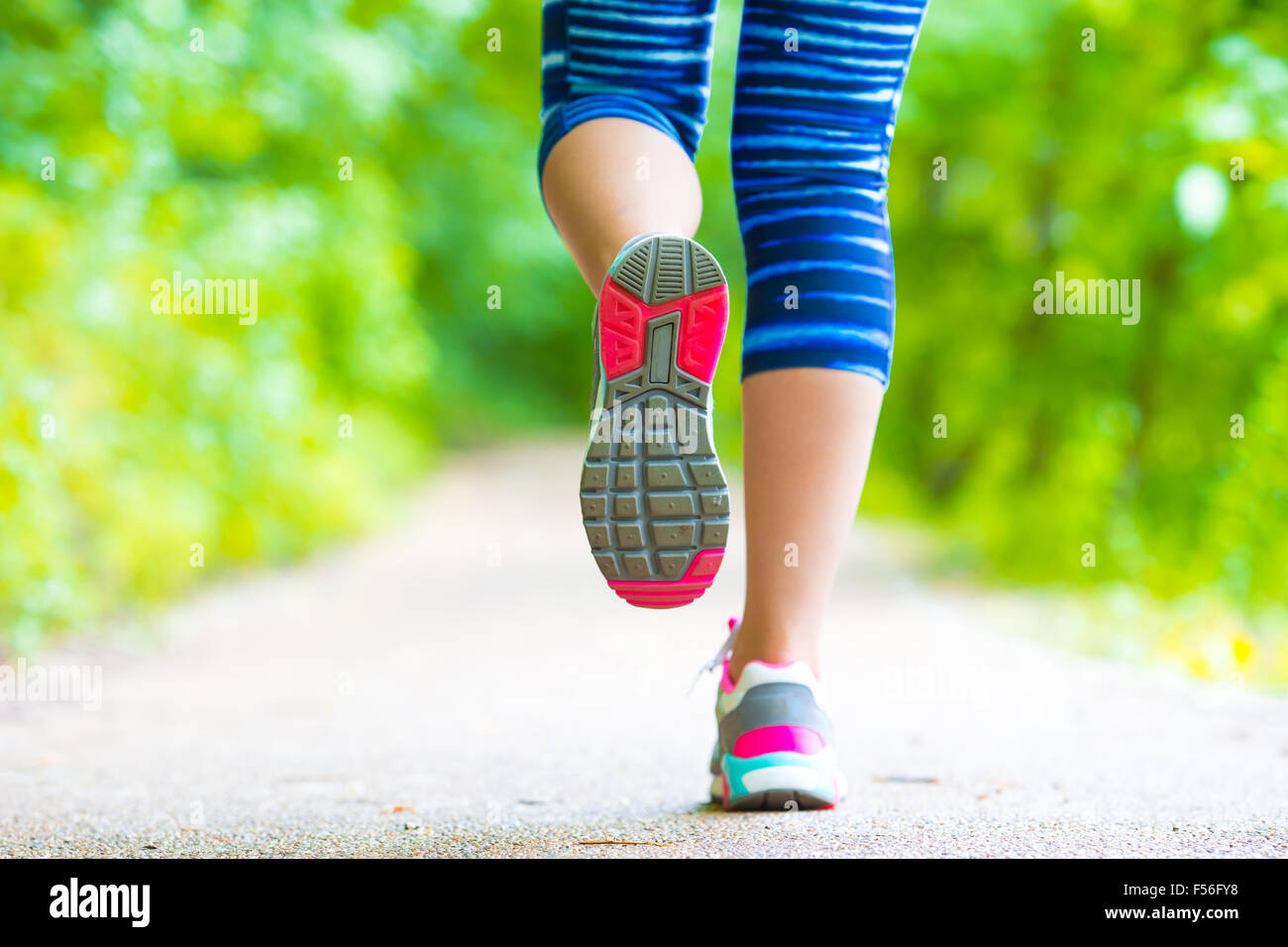 Close-up on shoe of athlete runner woman feet running on road Stock ...