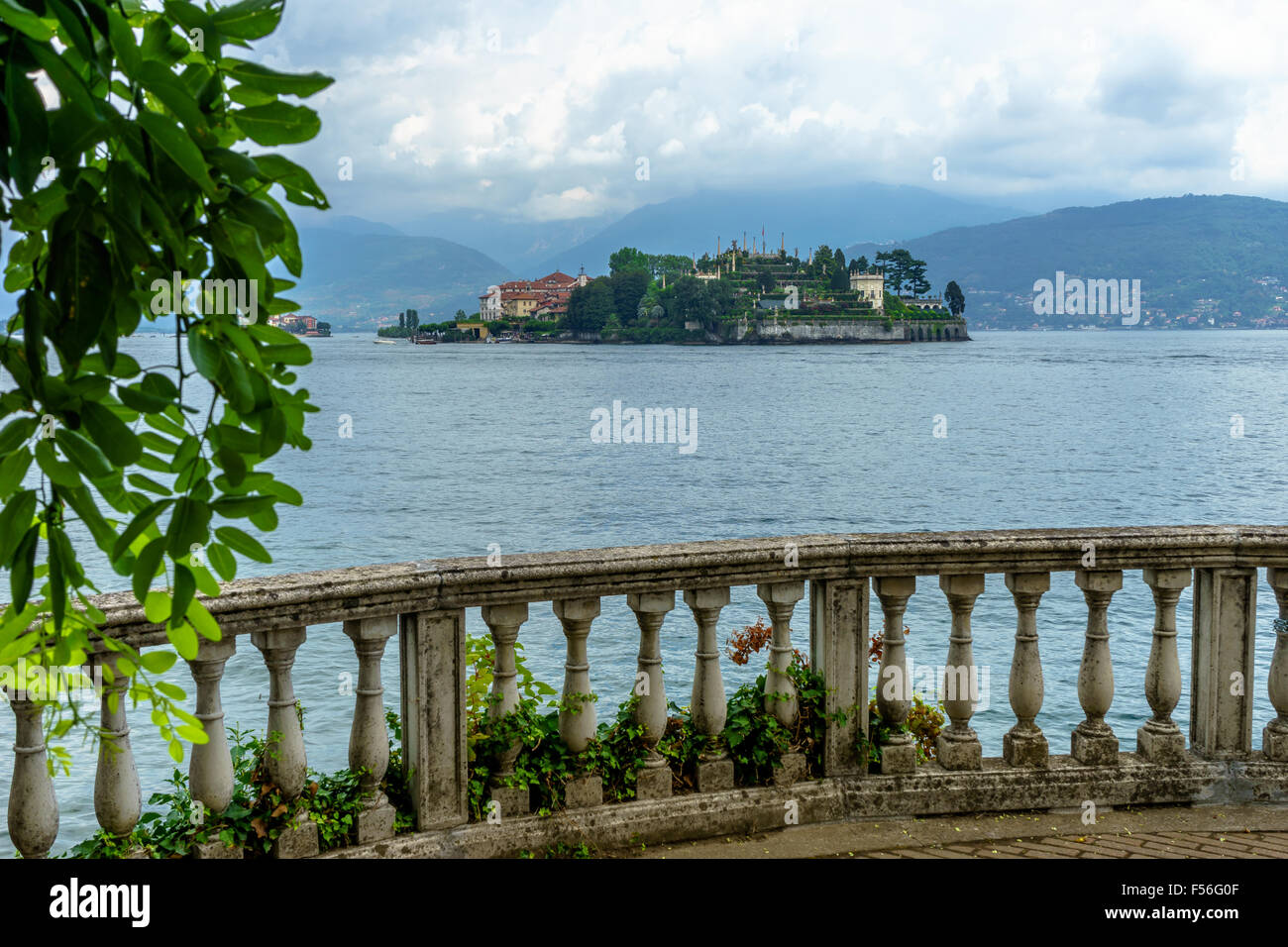 Vines and stone gate frame a view of Isola Bella on Lake Maggiore in ...