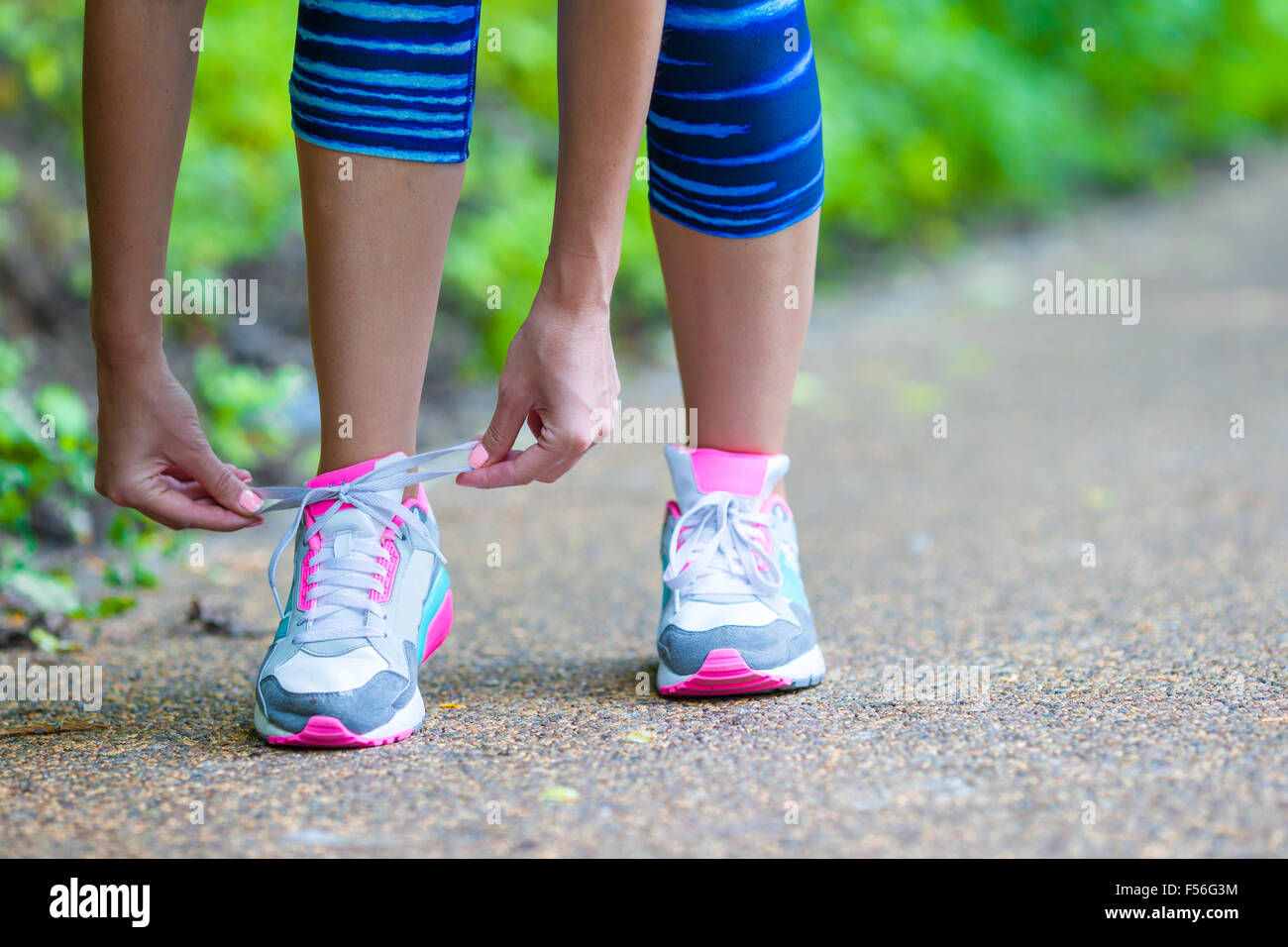 Close-up on shoe of athlete runner woman feet running on road Stock ...