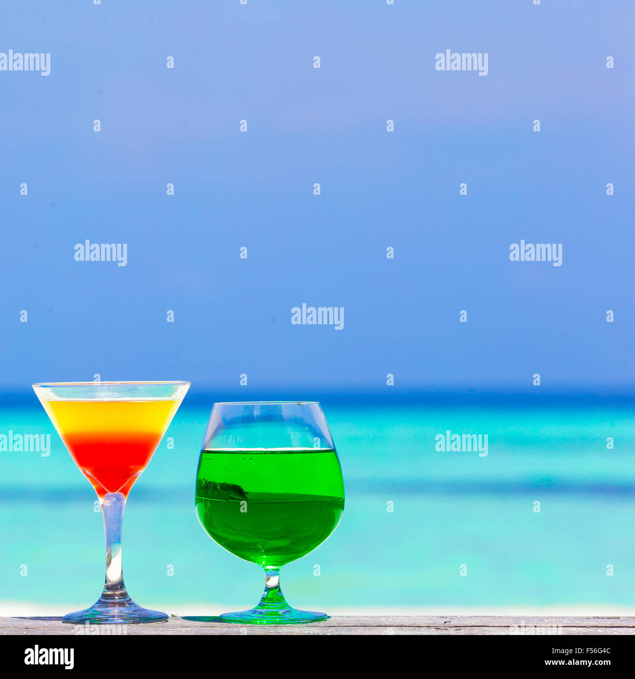 Colorful exotic tasty cocktails in outdoor cafe background turquoise ...