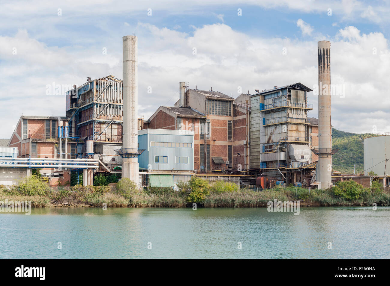 The old chemical factory with chimneys and silo on the banks of the ...