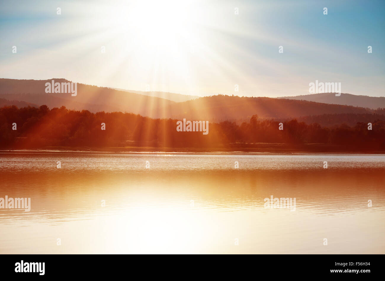 sun over lake Stock Photo - Alamy