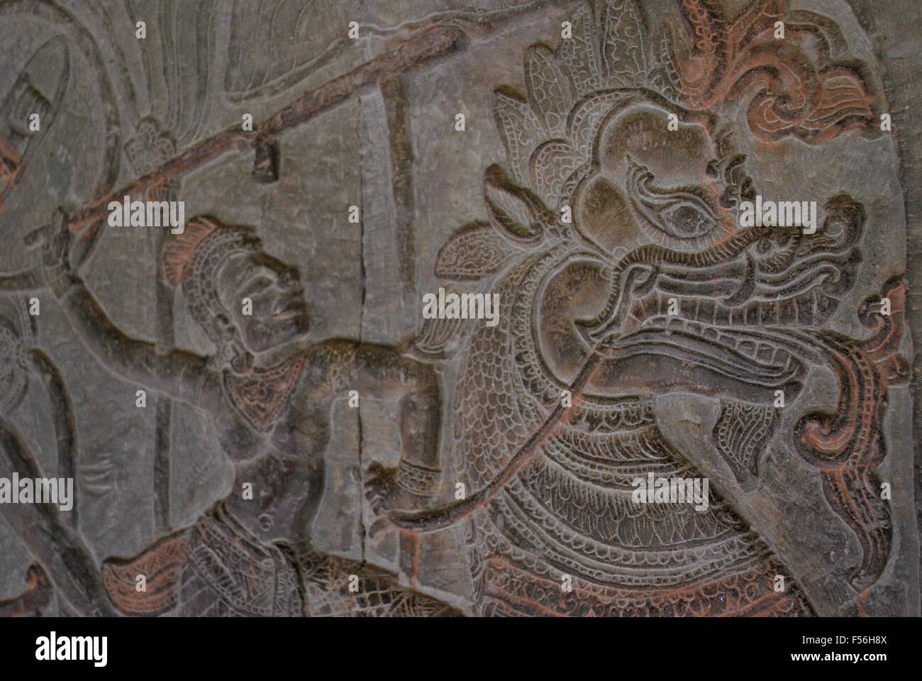 Ancient Khmer bas relief wall carving showing Hindu god on a dragon ...