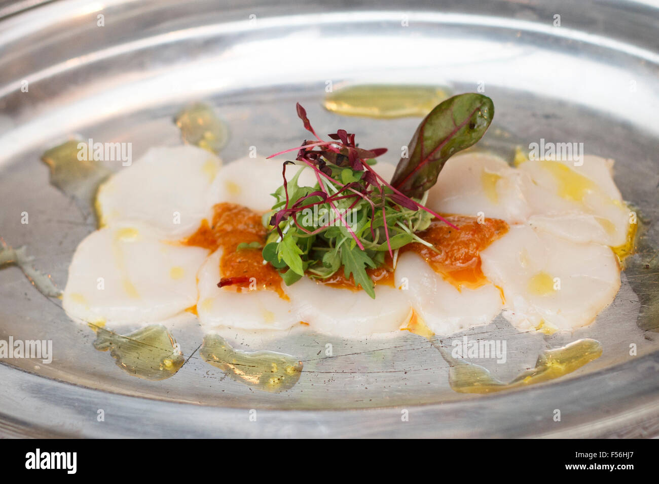 Carpaccio of Scallops with preserved lemon salsa and harissa Stock ...