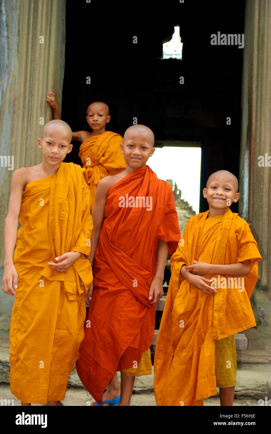 Four young Buddhist priests in a hallway inside the Angkor Wat complex ...