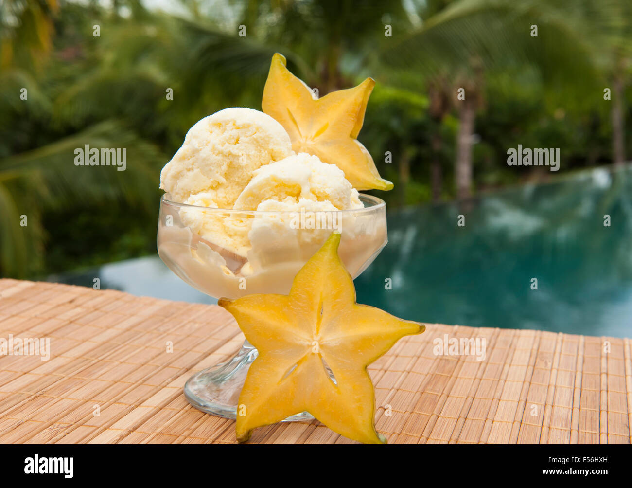 Dish of tropical starfruit ice cream by the pool with a tropical ...