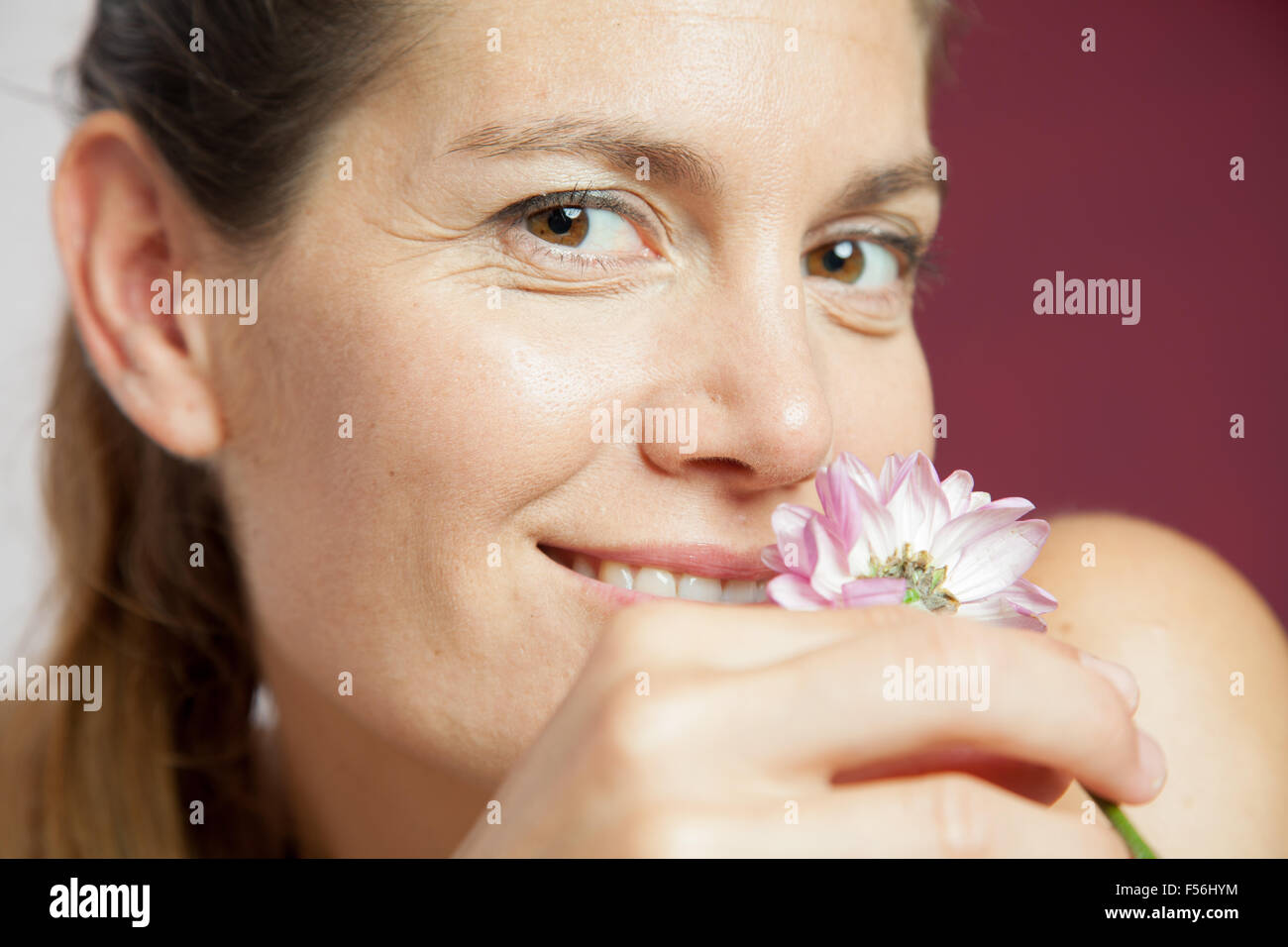 Pretty woman smelling flowers in spa Stock Photo - Alamy