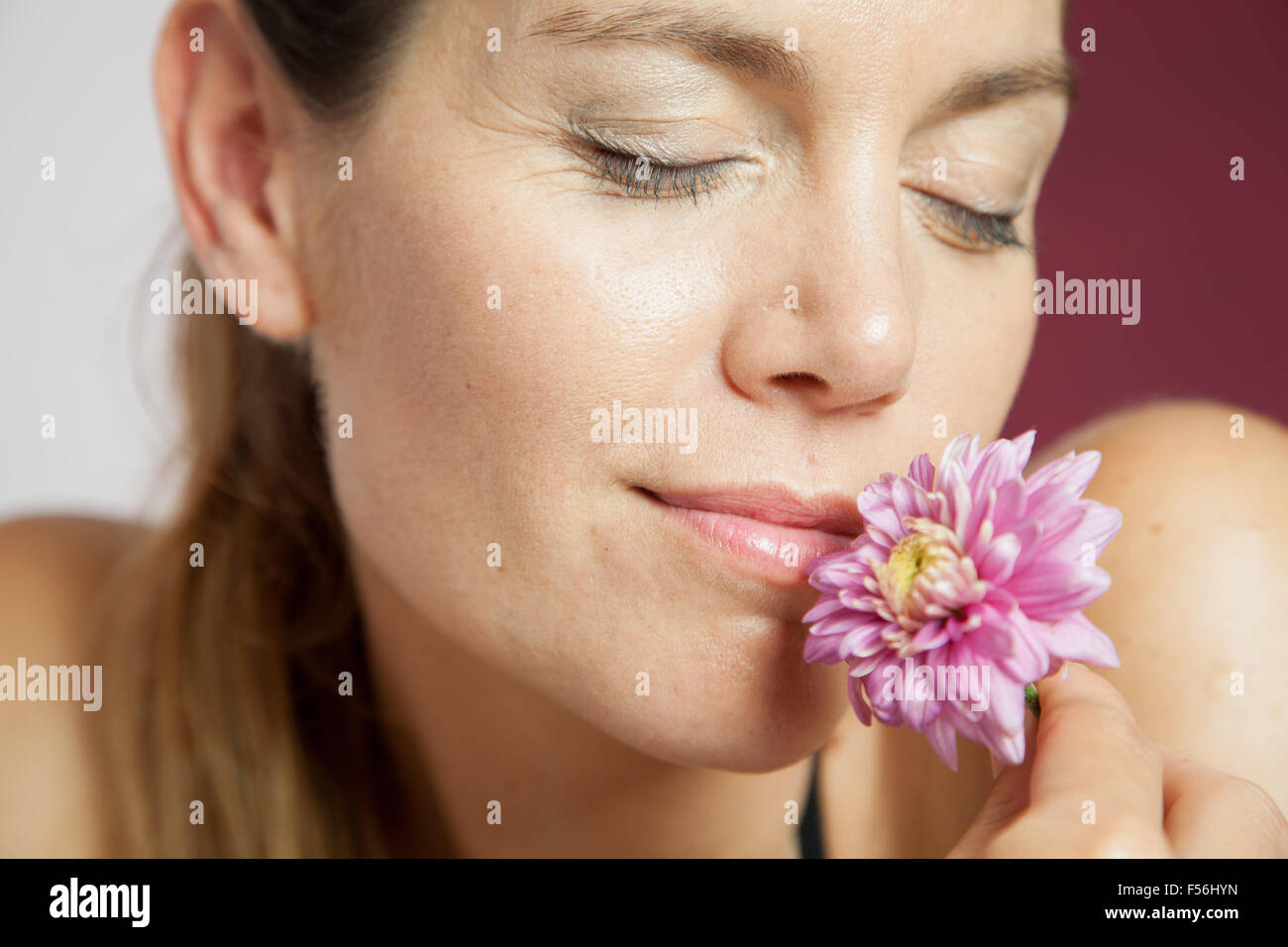 Pretty woman smelling flowers in spa Stock Photo - Alamy