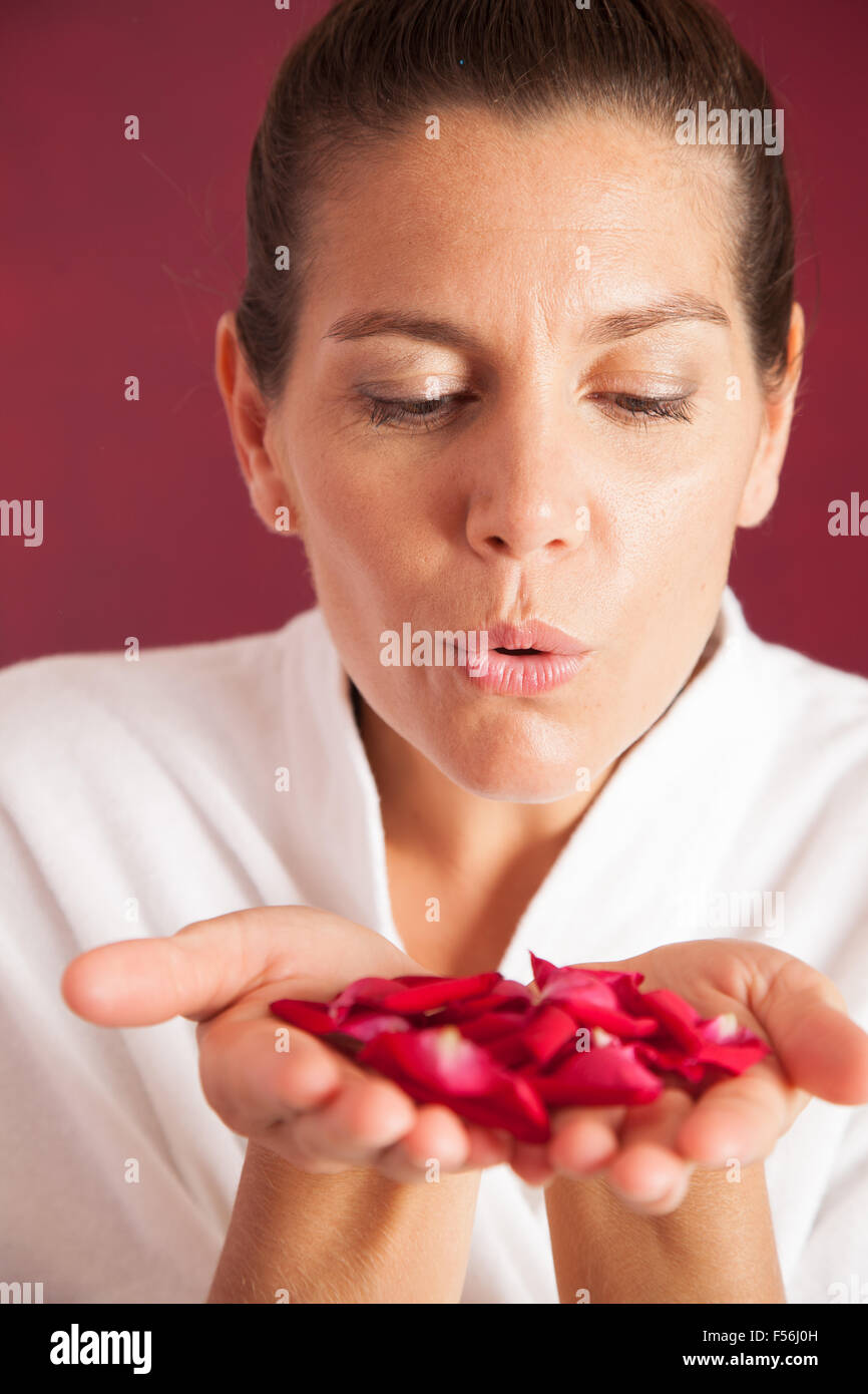 Pretty woman with rose petals Stock Photo - Alamy